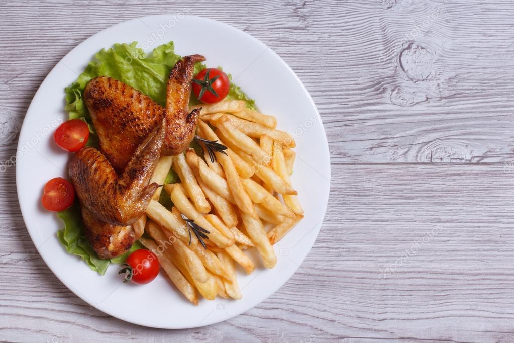 Two fried chicken wings, french fries. top view Stock Photo by ...