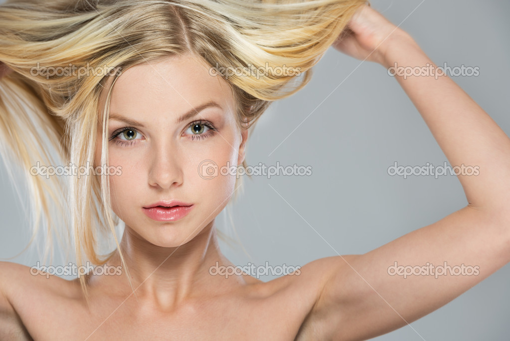 Portrait of blond girl rising up hair Stock Photo by ©CITAlliance 14916503