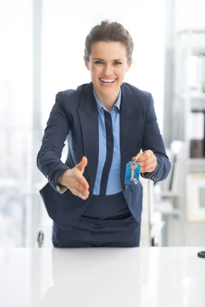 Business woman giving keys handshake - Stock Image - Everypixel