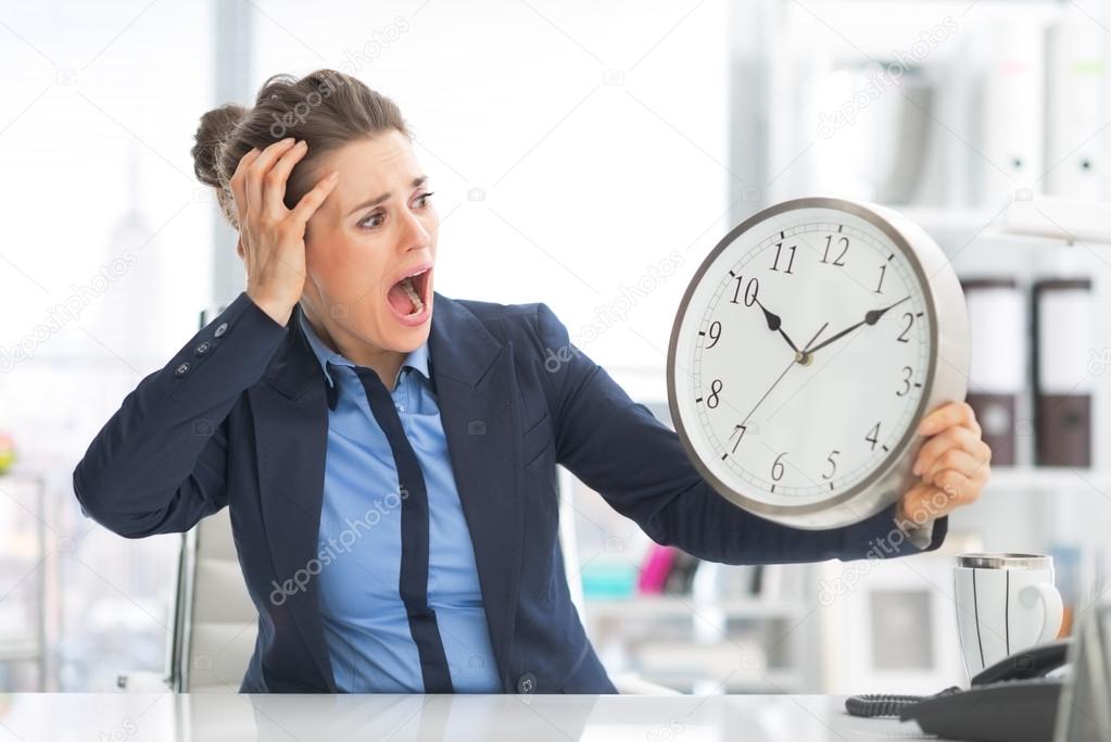 Business woman looking on clock Stock Photo by ©CITAlliance 44690579