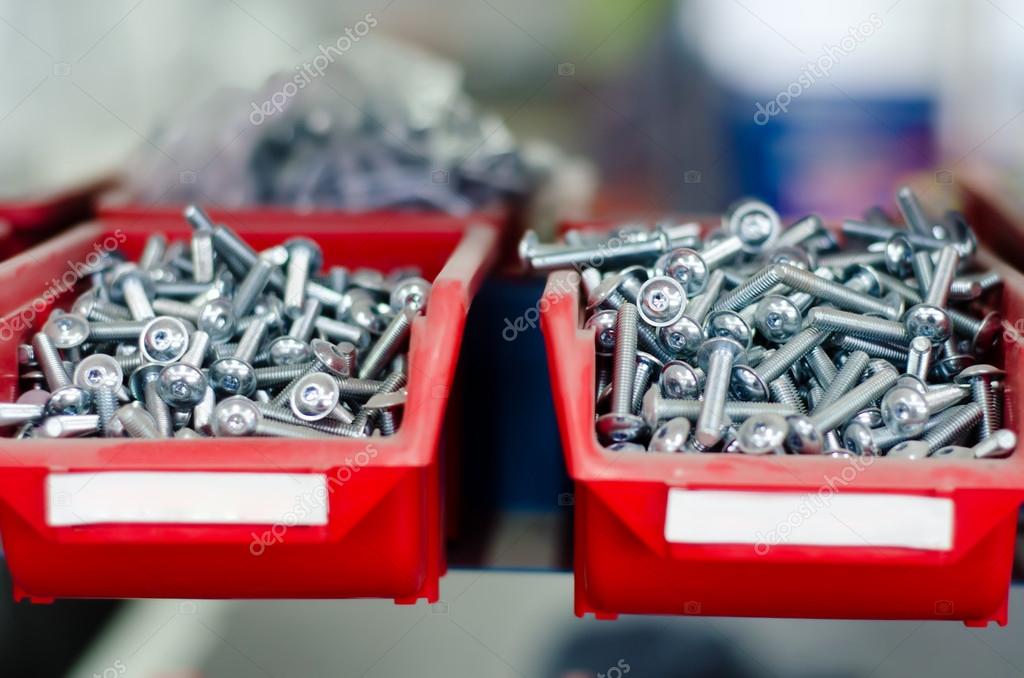 Red cabinets with screws and bolts in a modern factory — Stock Photo ...