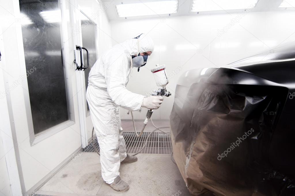 Automotive engineer working on painting a black car — Stock Photo ...