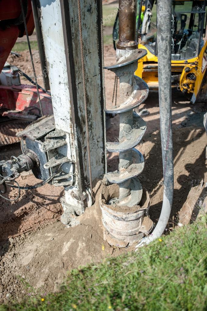 Close up of construction auger, industrial drilling rig making a hole ...