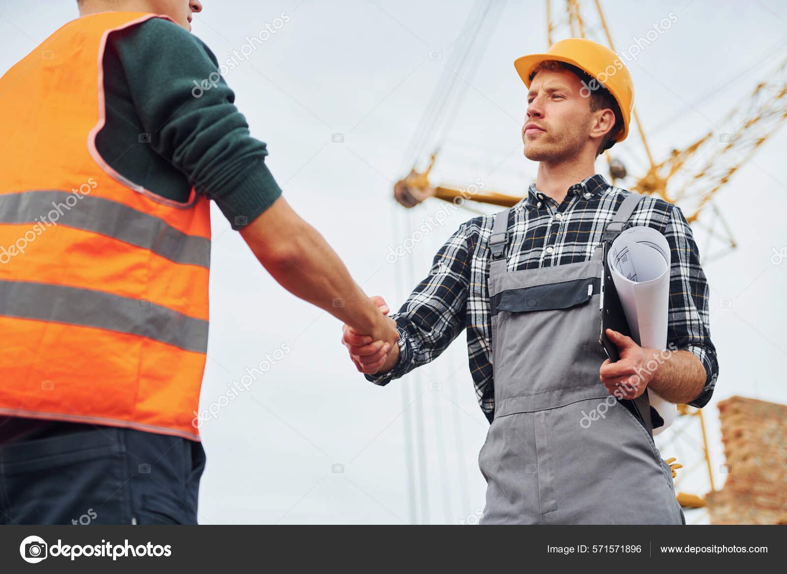 Making Handshake Two Construction Workers Uniform Safety Equipment Have ...