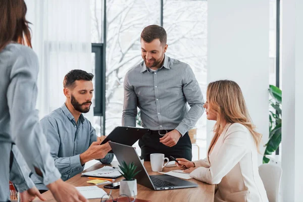 Sharing some ideas. Group of business people that working on the ...