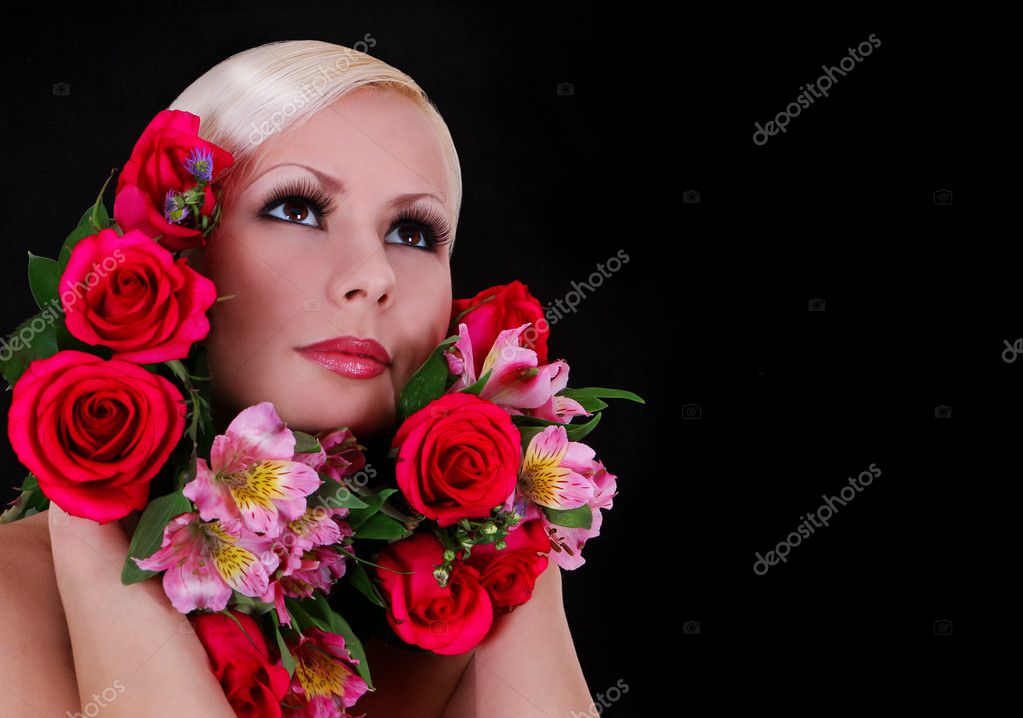 Fashion model with beautiful flowers over black background, blonde ...
