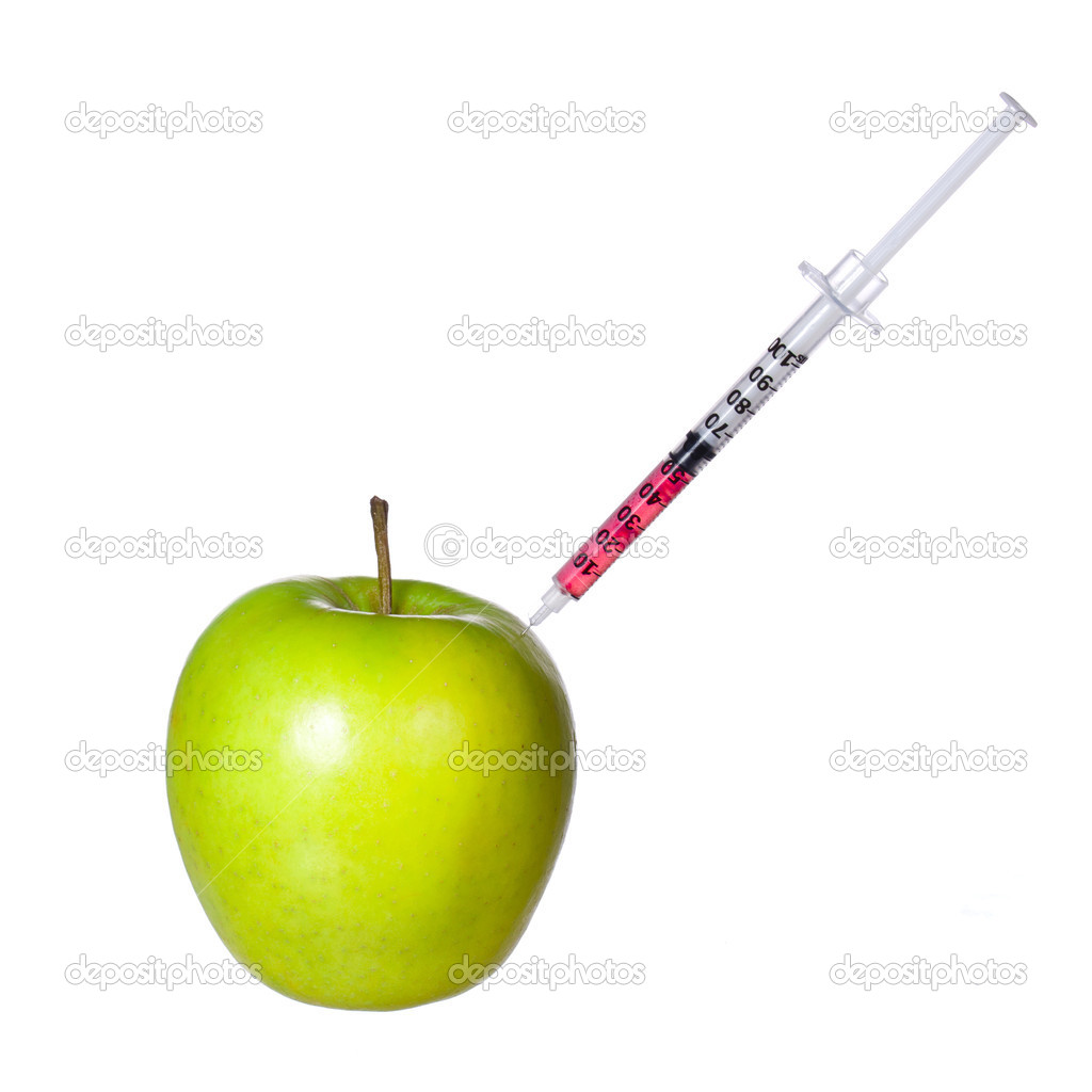 Genetically modified green apple and syringe isolated on white ...