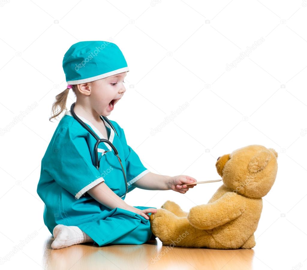 Adorable child dressed as doctor playing with toy over white — Stock ...