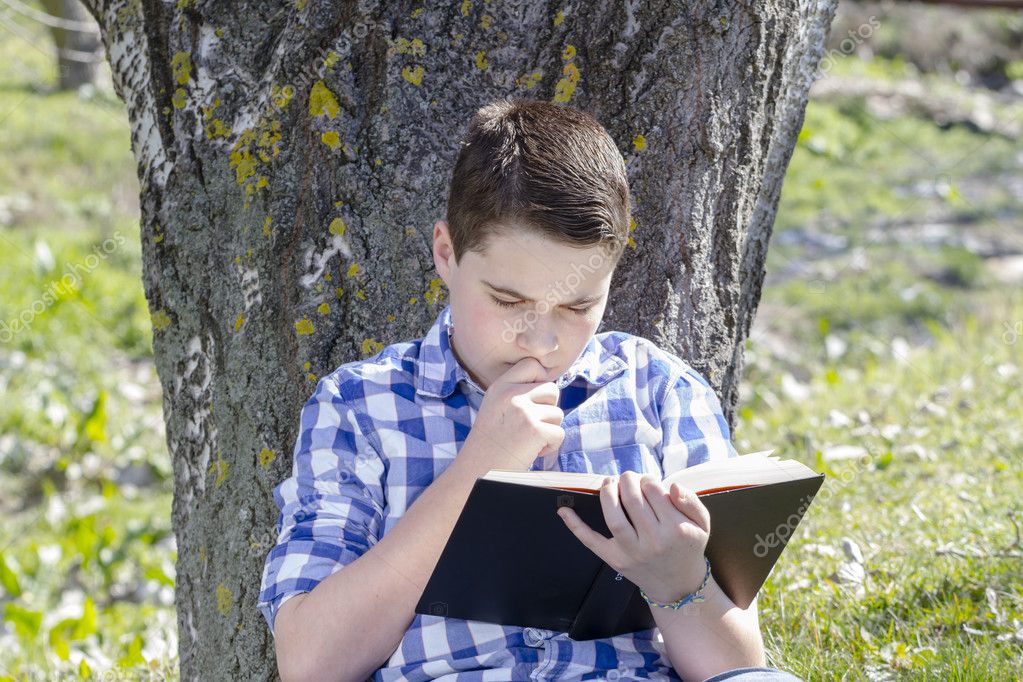 Young boy reading a book Stock Photo by ©outsiderzone 42458927