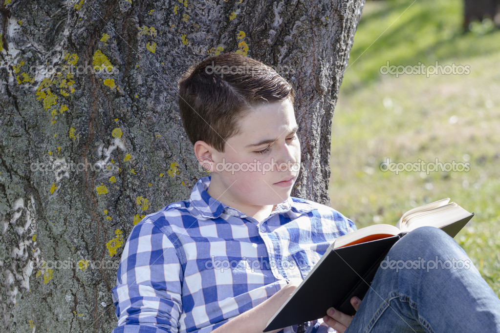 Young boy reading a book Stock Photo by ©outsiderzone 42459145