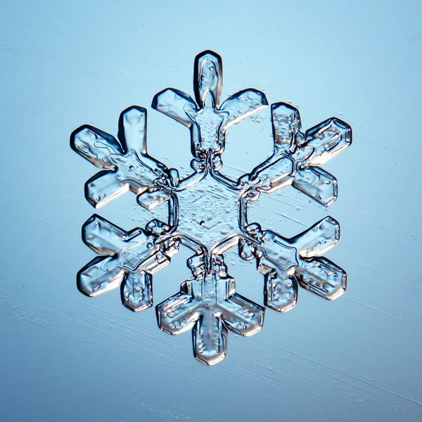 Light blue crystal snowflake on glossy white Stock Photo by ©madbit 8834652