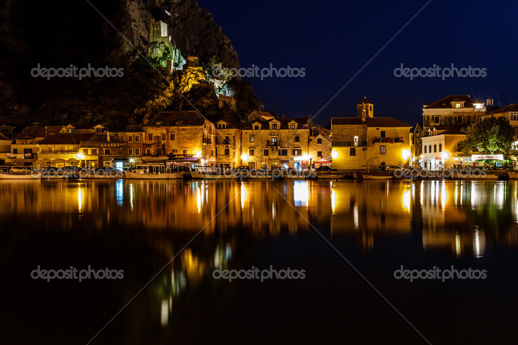 Illuminated Pirate Castle and Town of Omis Reflecting in the Cet ...