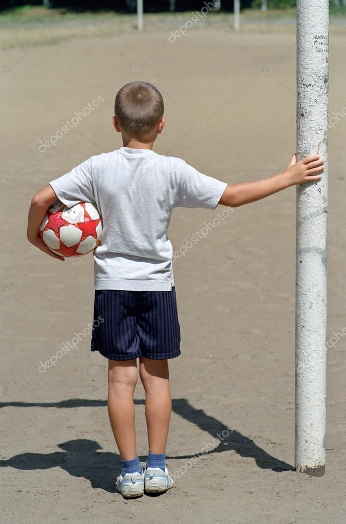 Boy with football, back view — Stock Photo © mike_kiev #12261530