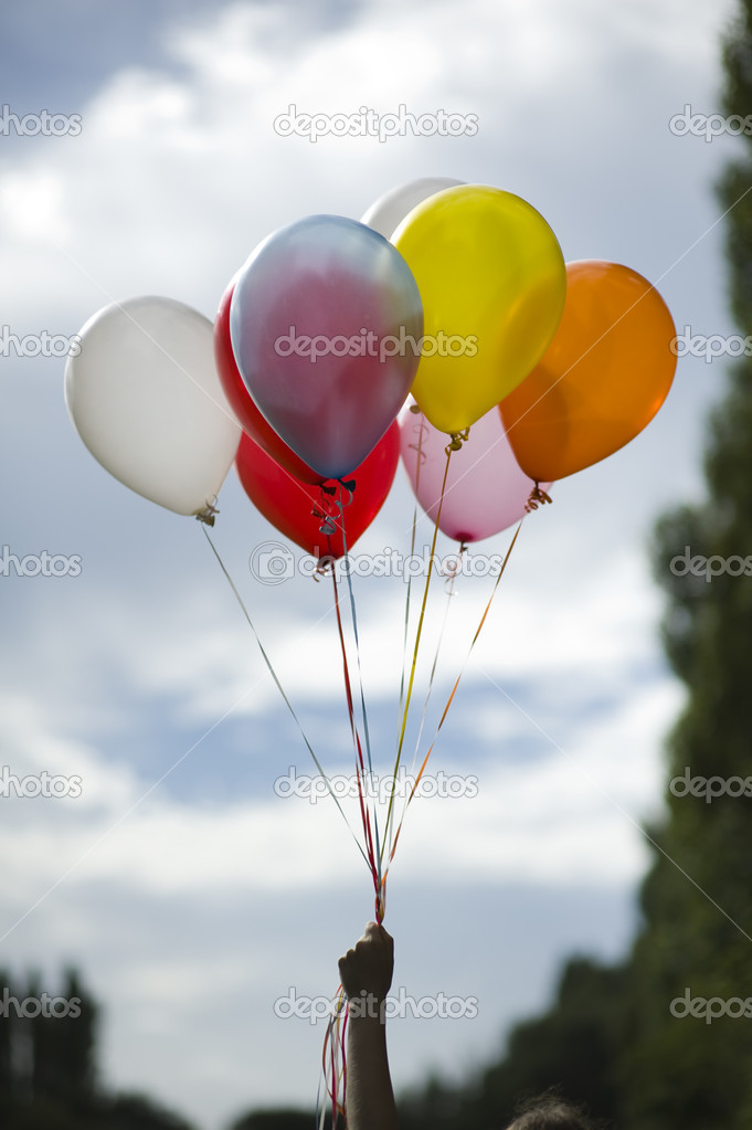 Person holding colored helium balloons Stock Photo by ©eelnosiva 12852694 Person holding colored helium balloons Stock Photo by ©eelnosiva 12852694
