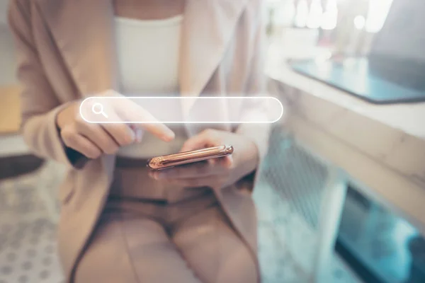 Women use smartphones to find what they are interested in. Searching information data on ...