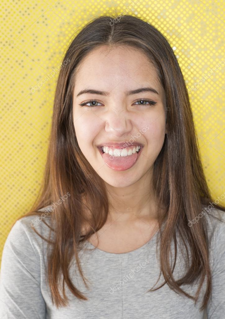 Teasing young woman sticking out tongue — Stock Photo © larshallstrom ...