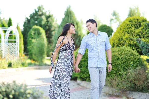 Young beautiful couple walking together in a park - Stock Image - Everypixel