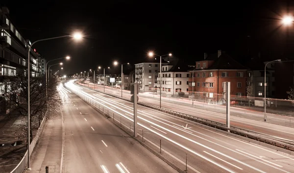 Urban city road with car light trails at night — Stock Photo ...