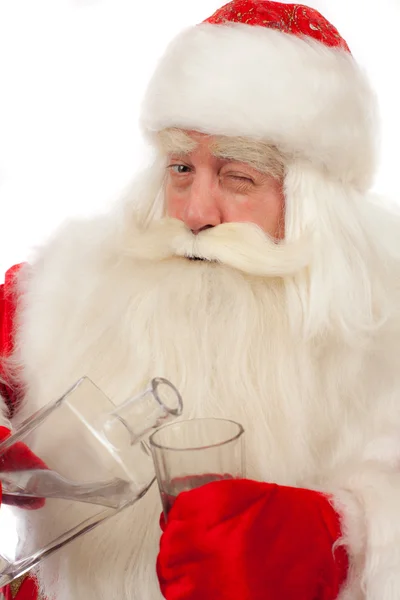 Santa Claus drinking milk from bottle — Stock Photo © HASLOO #31418007