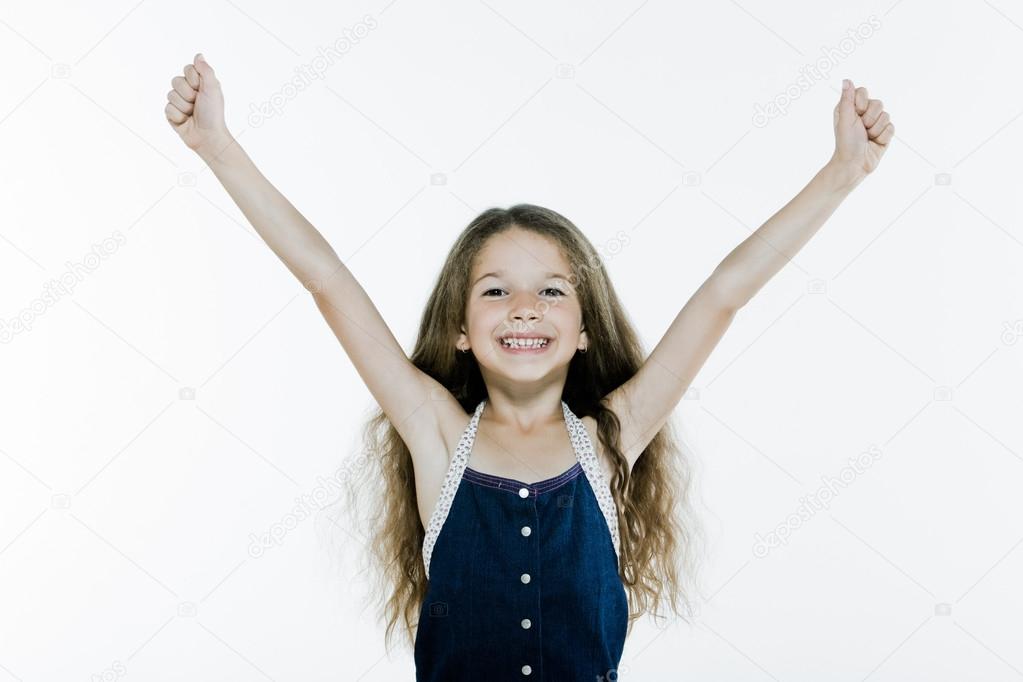 Successful happy little girl amrs raised Stock Photo by ©STYLEPICS 33318089