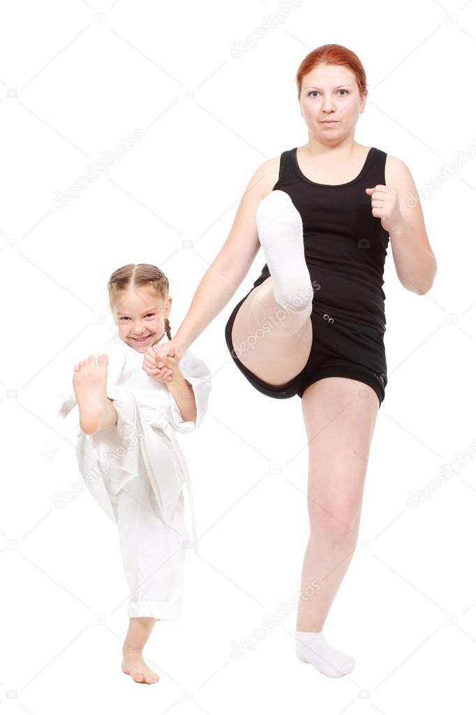 Mom and daughter hit a karate kick leg Stock Photo by ©Andreyfire 27659455