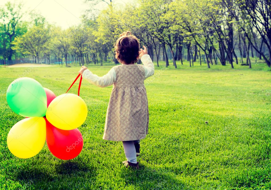 Child with balloons and walking in park Stock Photo by ©uroszunic 43889439
