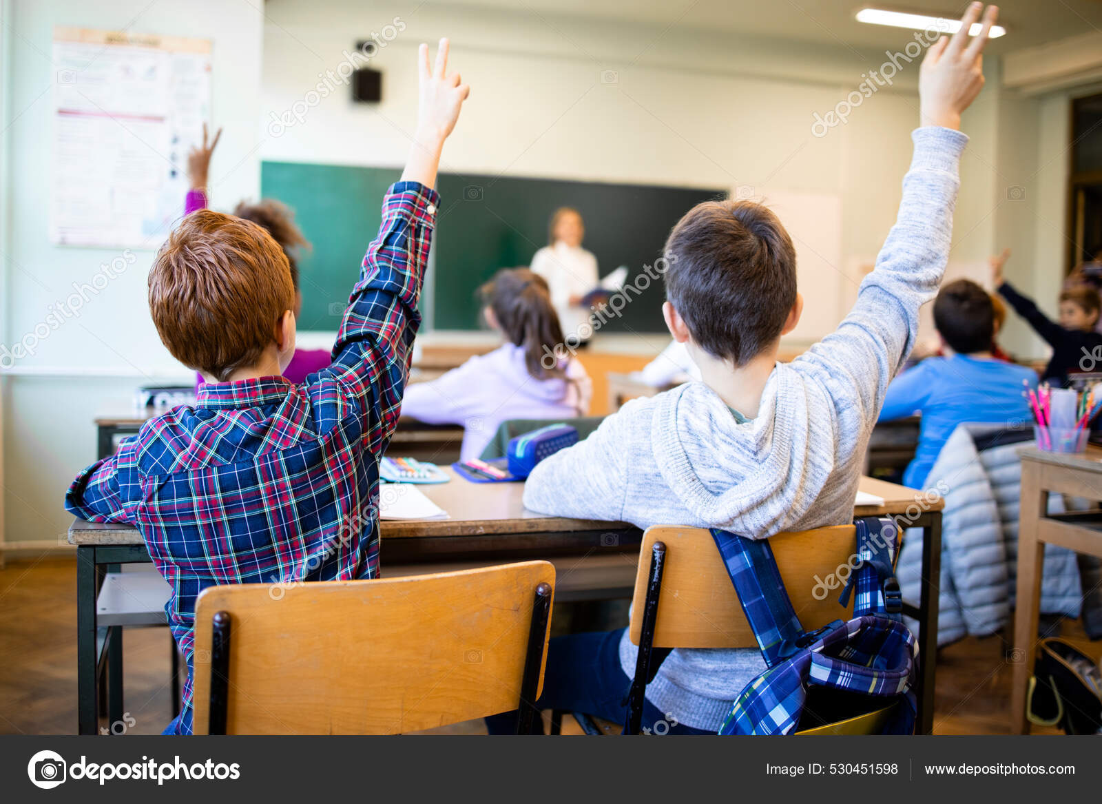 Schoolchildren Classroom Raised Hands Answering Teacher's Question ...