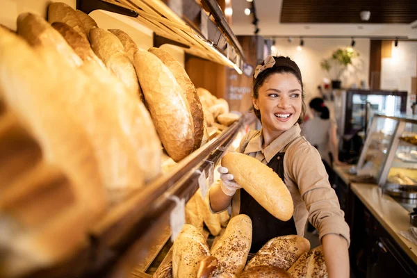 Portrait of beautiful female baker working in bakery shop. - Stock ...