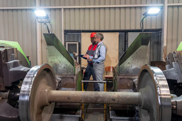 African American CNC Machine Operator Talking To Caucasian Production ...