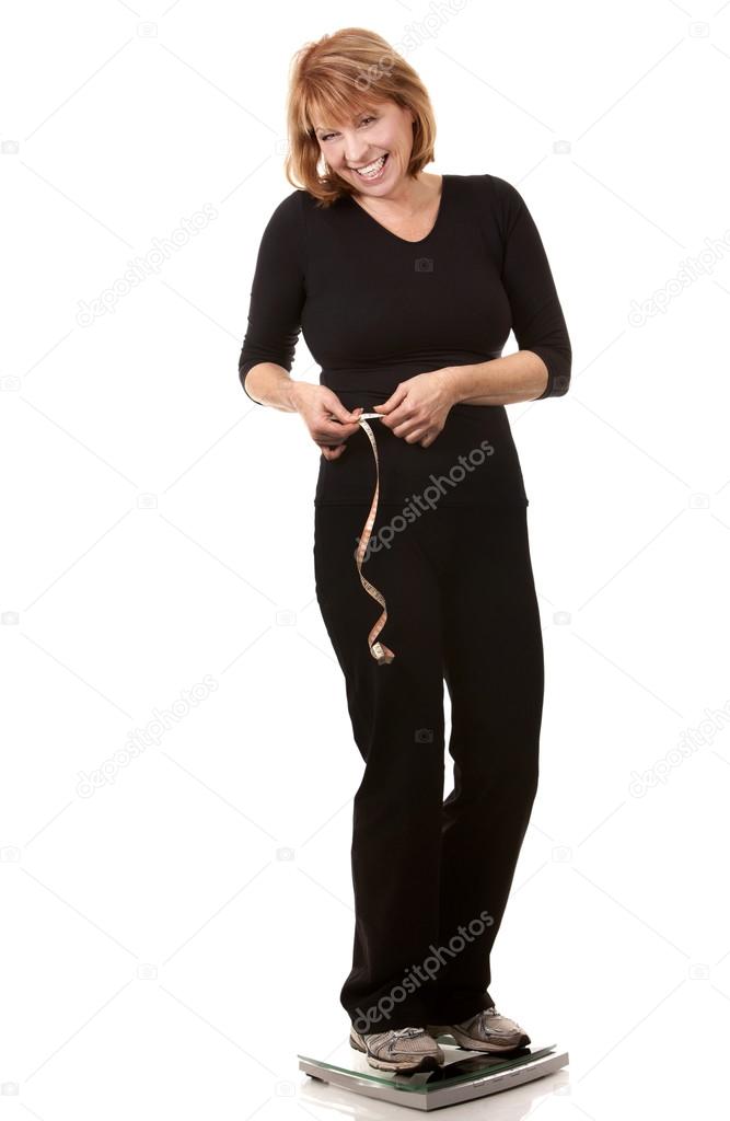 Woman standing on scale Stock Photo by ©zdenkam 36681889