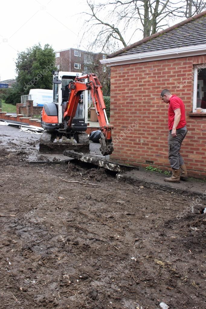 A mini digger excavating a driveway – Stock Editorial Photo © 1markim ...