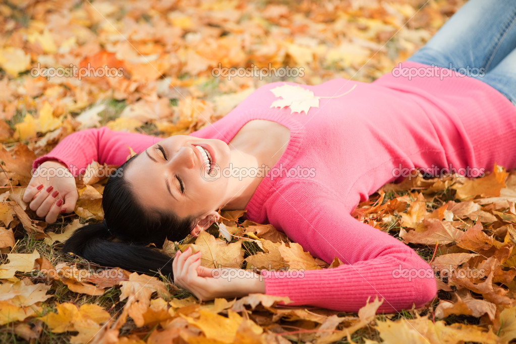 Young pretty woman relaxing in the autumn park Stock Photo by ©suravid ...
