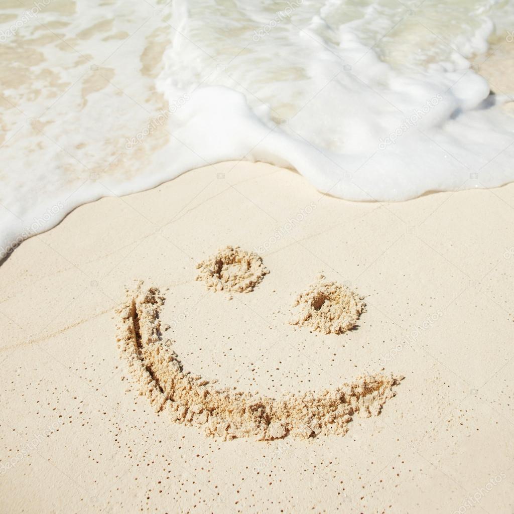 Symbol "smile" on beach background Stock Photo by ©suravid 34486779