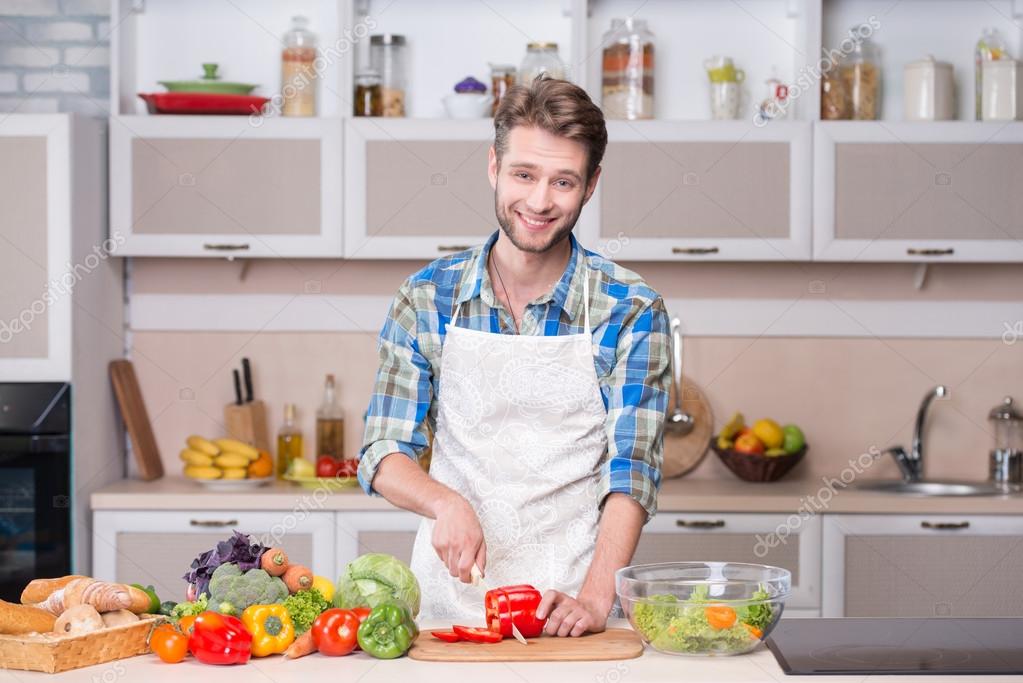 Young smiling man cooking dinner in kitchen — Stock Photo © dima ...