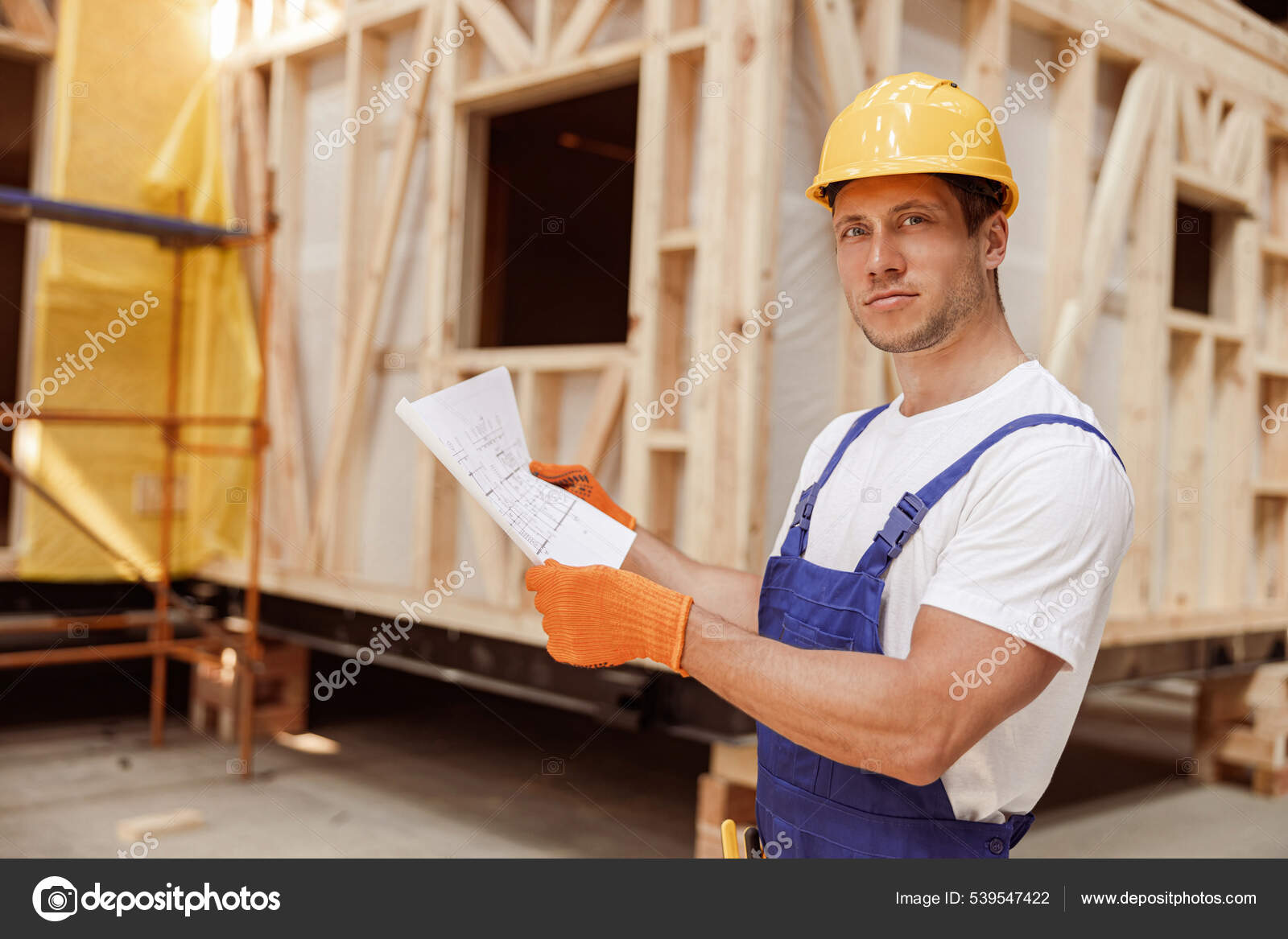 Handsome man studying architectural plan at construction site Stock ...