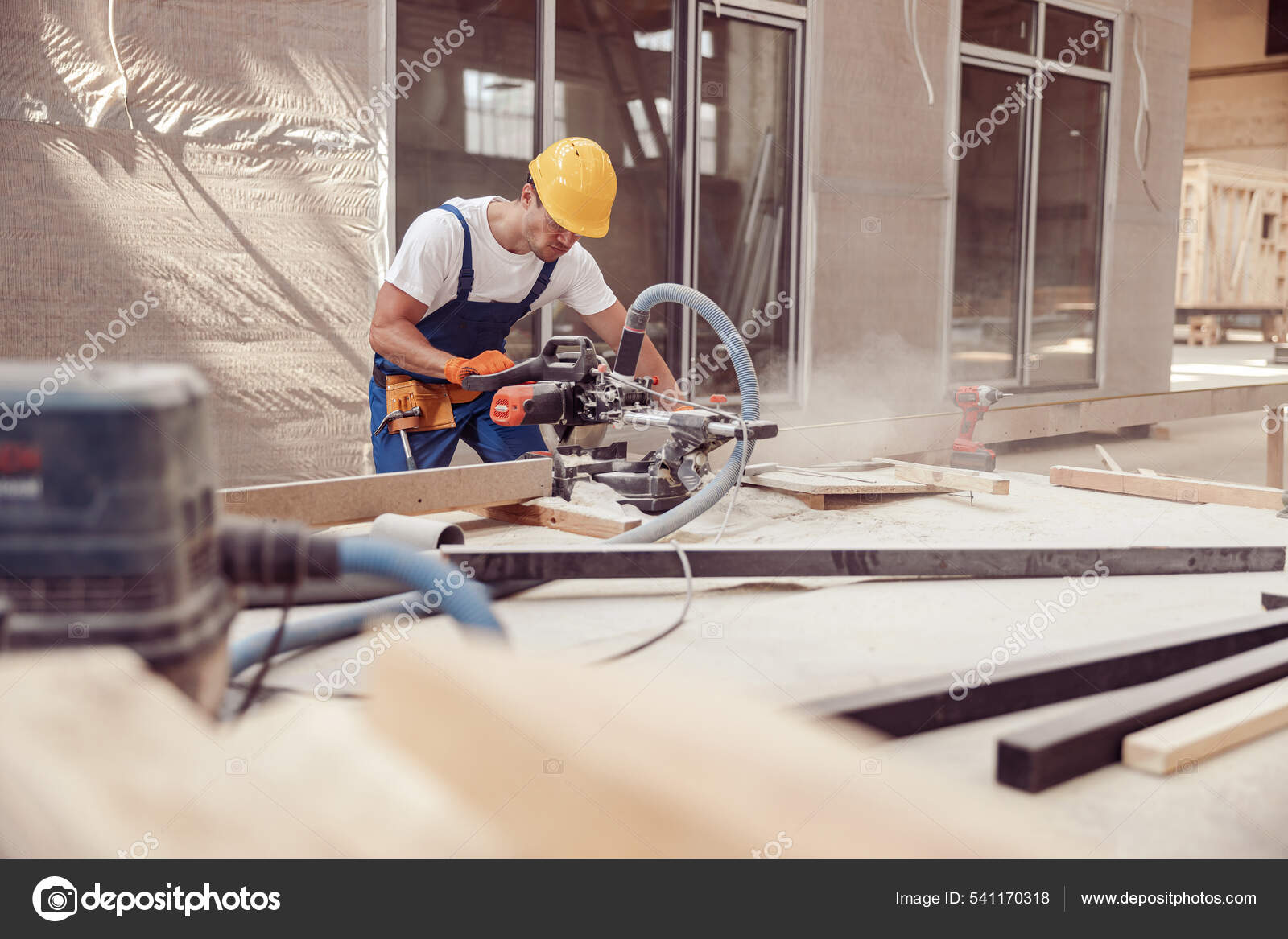 Male worker using wood cutting circular saw machine Stock Photo by ...