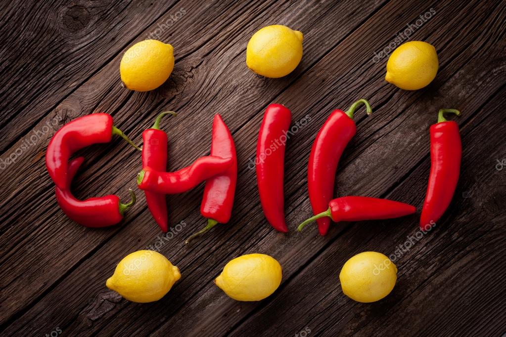 Chilli sign with fresh chillies and lemons Stock Photo by ©annabieniek ...