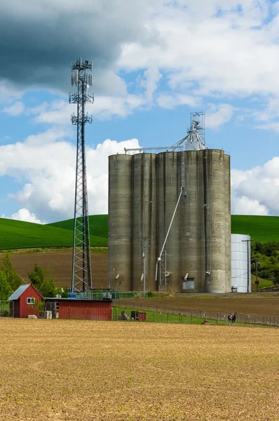 Grain silo with a cell phone tower - Stock Image - Everypixel