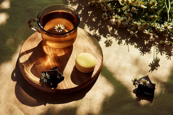 Aesthetic brunch of tea time, herbal tea and macarons dessert outside ...