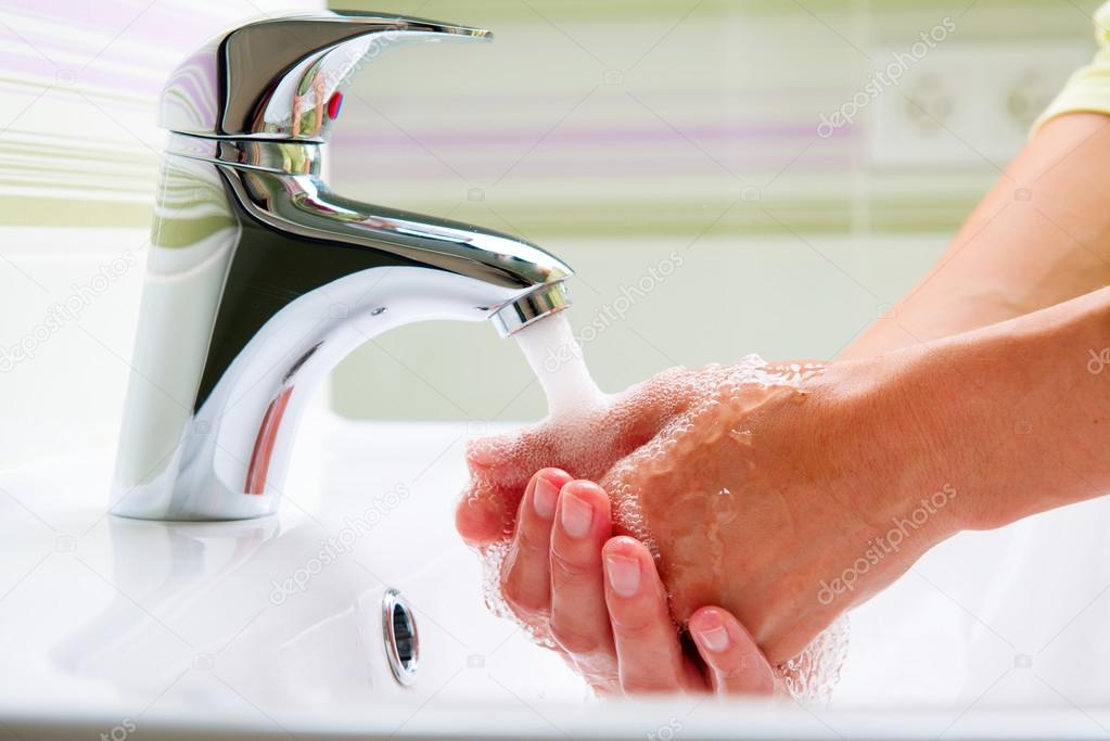 Woman Cleaning Hands in a Bathroom — Stock Photo © Subbotina #48639955