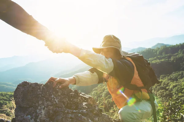 Close-up of helping hand, hiking help each other. Focus on hands ...