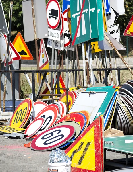 Stack of different traffic road signs on ground Stock Photo by ©quka ...