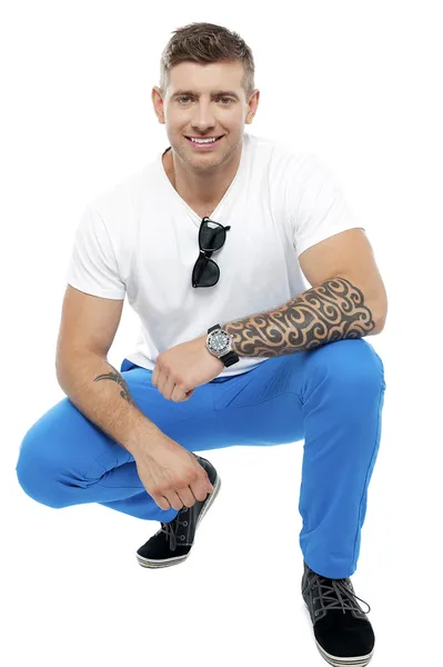 Handsome male bouncer squatting position Stock Photo by ©stockyimages ...