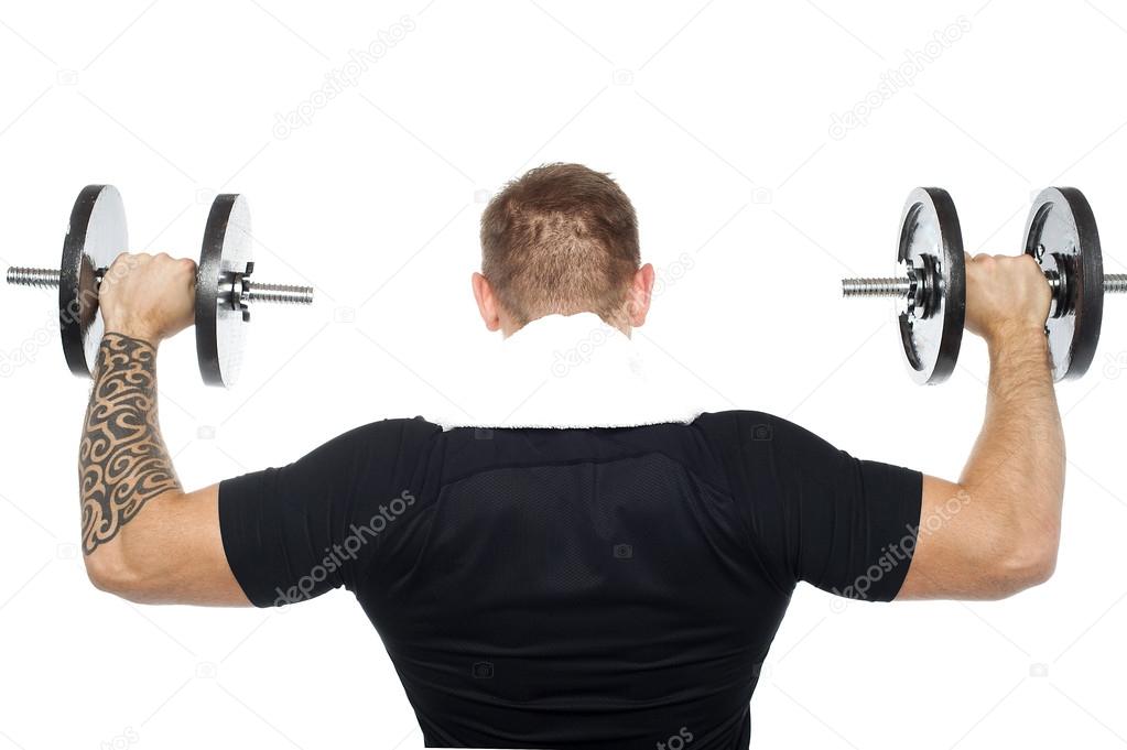 Back pose of male bodybuilder lifting weights Stock Photo by ...