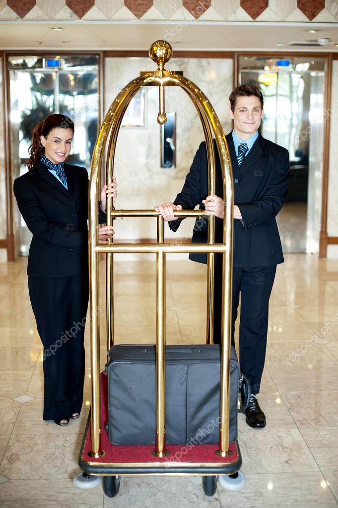 Concierge colleagues holding baggage cart ⬇ Stock Photo, Image by ...