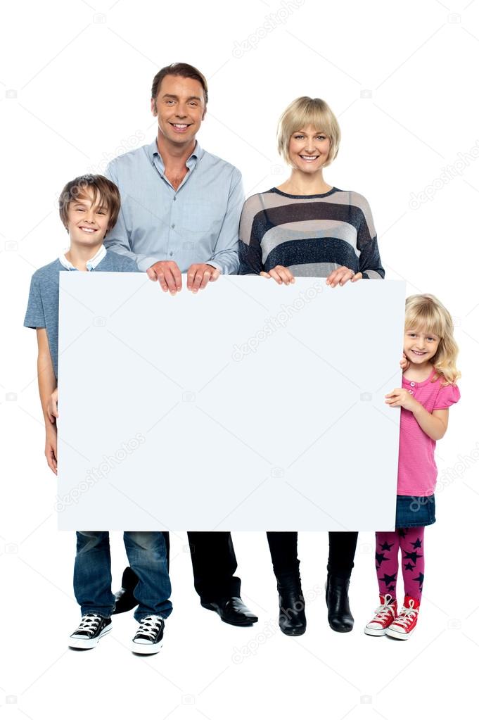 Active young family displaying blank ad board Stock Photo by ...