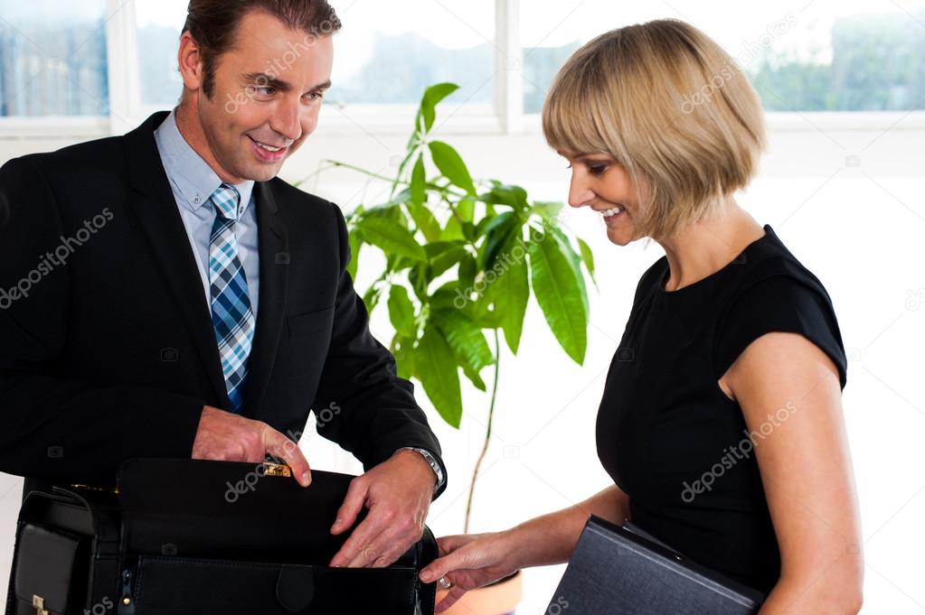 Boss opening his briefcase in front of secretary Stock Photo by ...