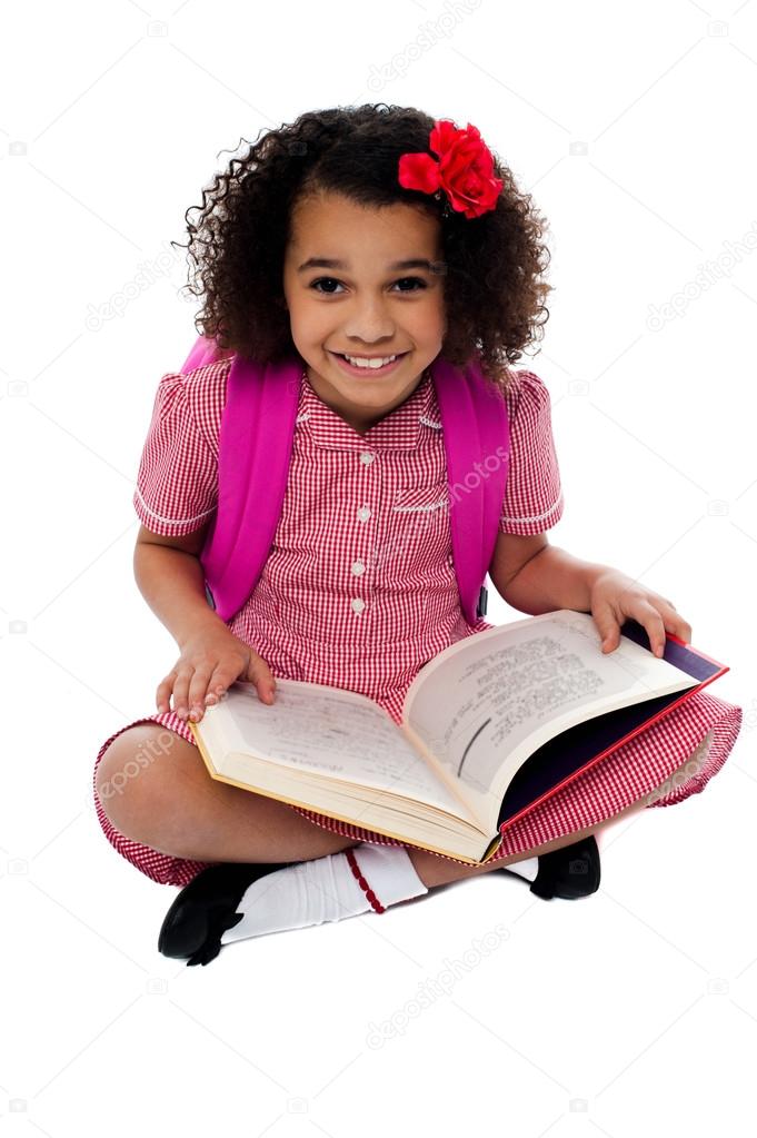 Smiling pretty school girl reading a book — Stock Photo © stockyimages ...