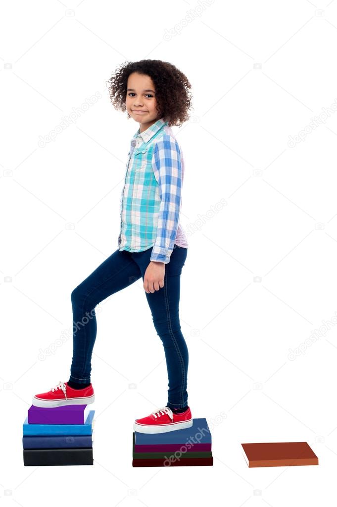 Girl child taking steps ahead made from notebooks Stock Photo by ...