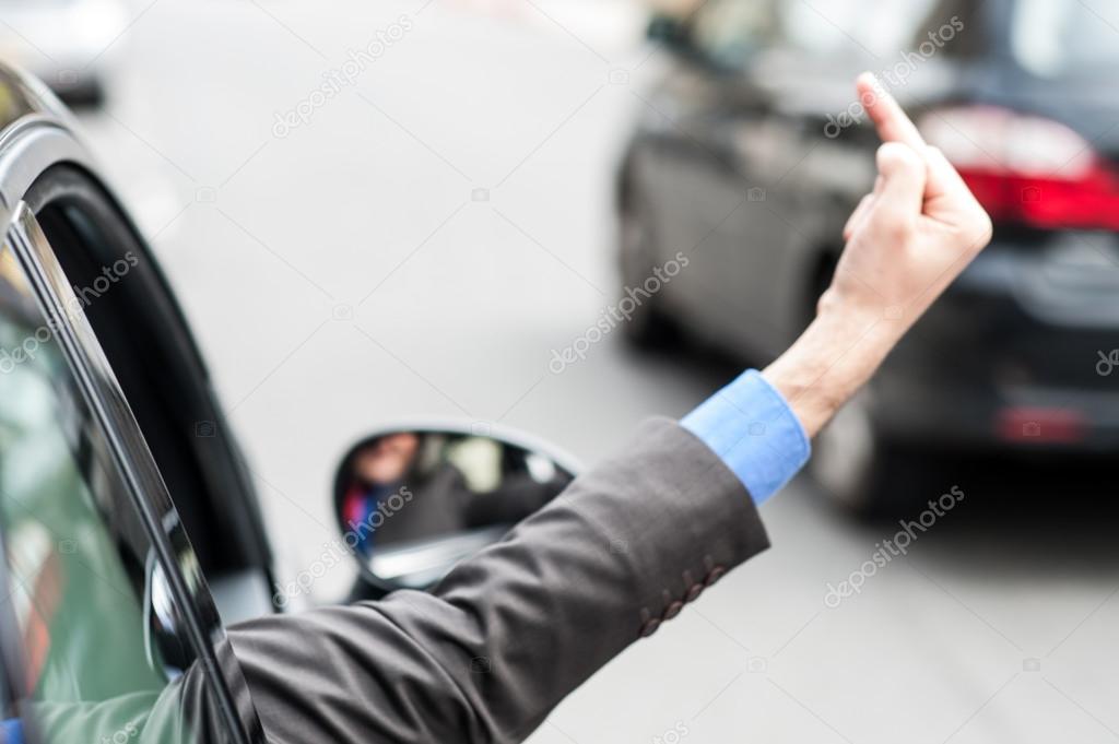 Man showing middle finger from car window — Stock Photo © stockyimages ...
